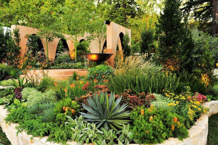 A luxuriant, resort style garden with lagoons and a waterfall feature