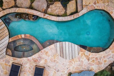 A Freeform Pool Enhanced with Natural Stone Paving - Completehome