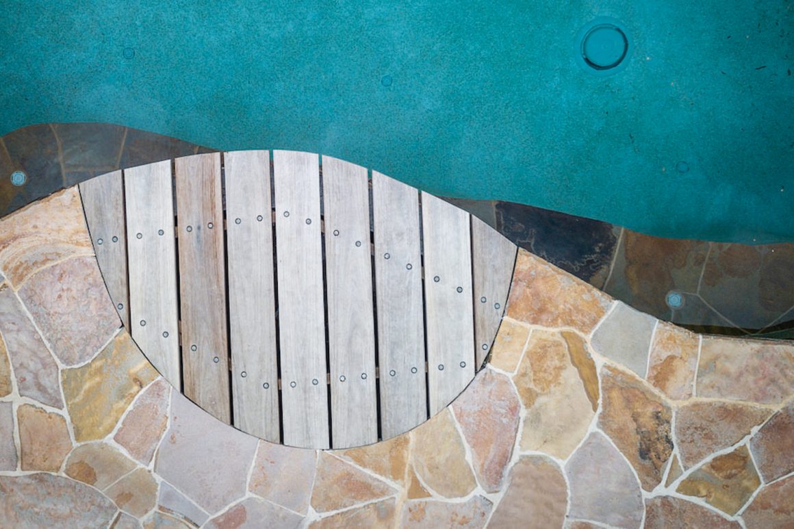 A Freeform Pool Enhanced with Natural Stone Paving - Completehome